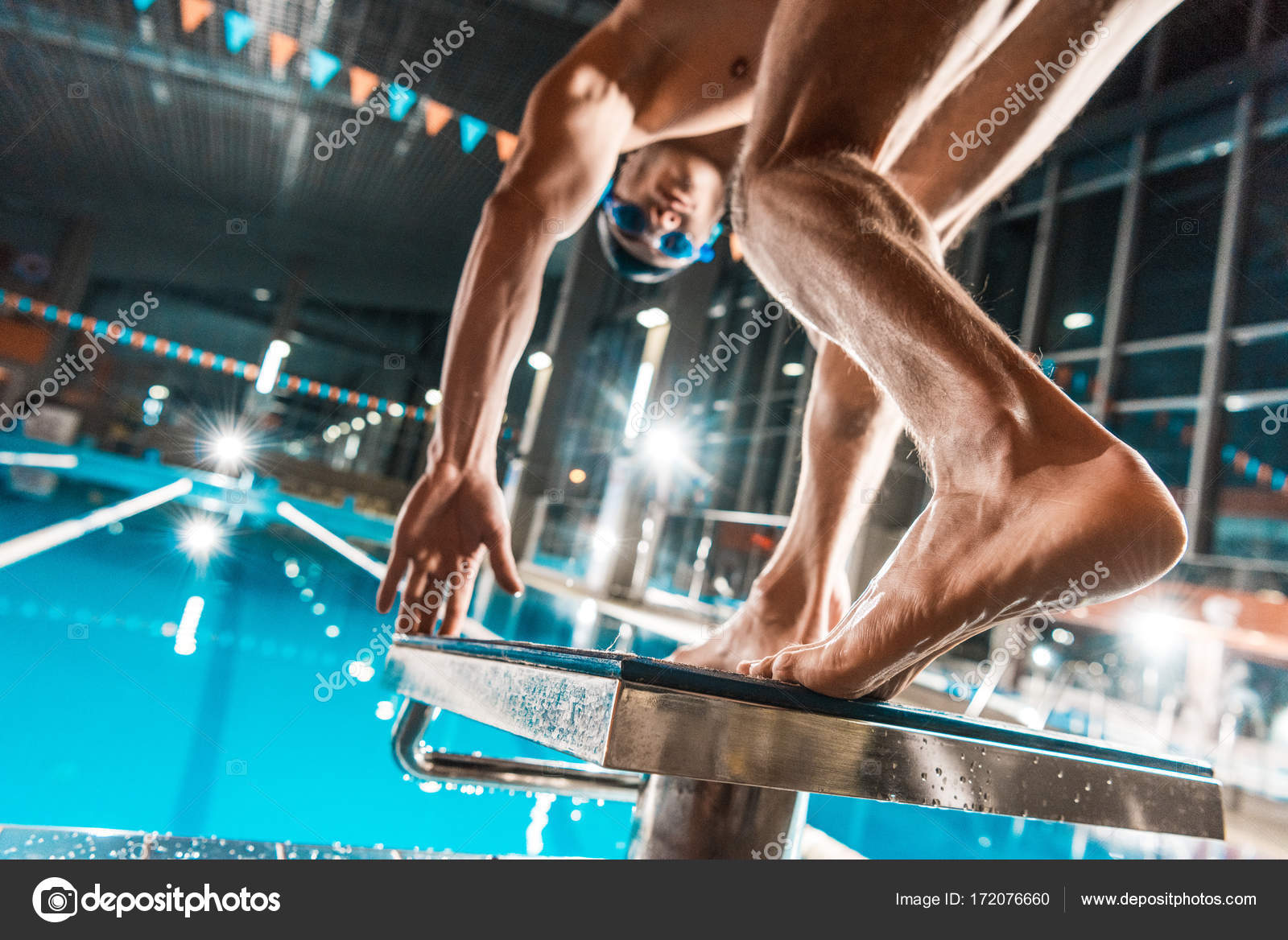 Swimmer jumping into pool — Stock Photo © ArturVerkhovetskiy #172076660