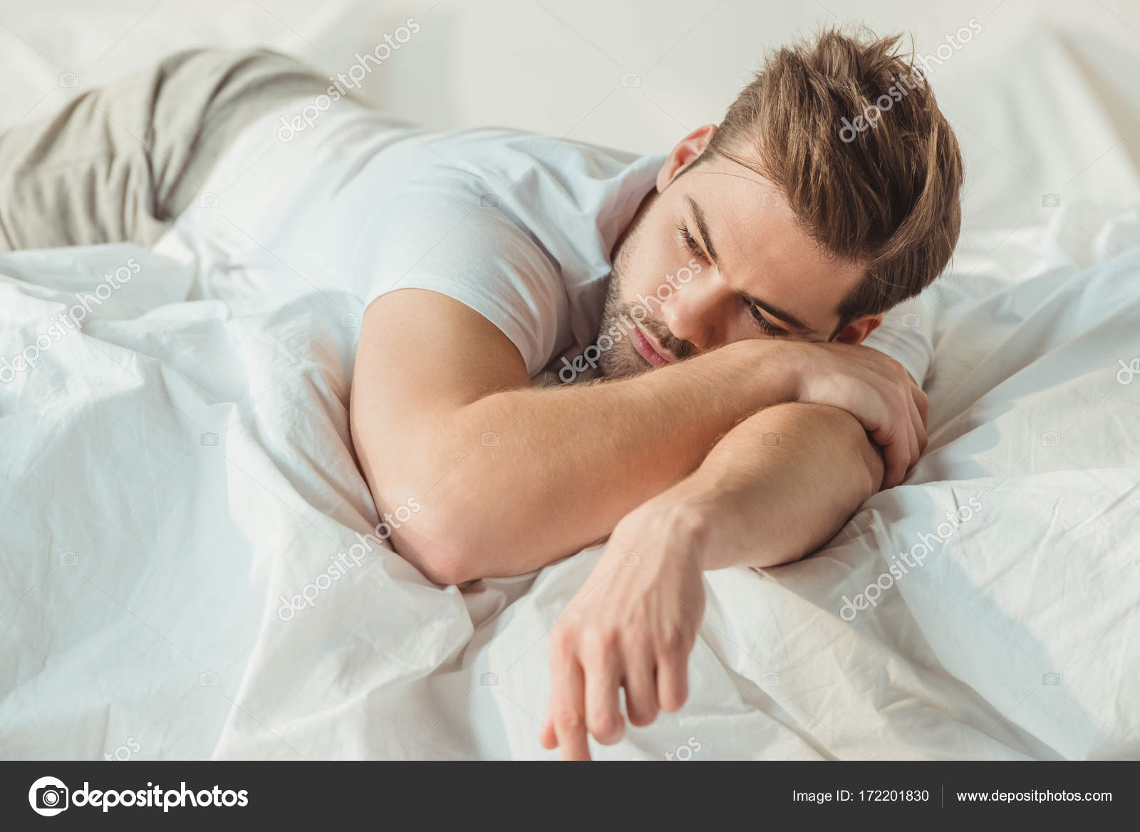 Man relaxing in bed — Stock Photo © ArturVerkhovetskiy #172201830