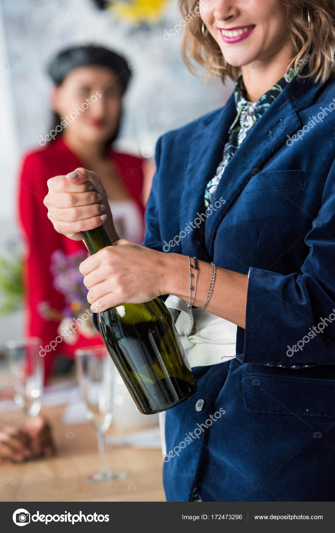 Woman opening champagne bottle — Stock Photo © ArturVerkhovetskiy #172473296