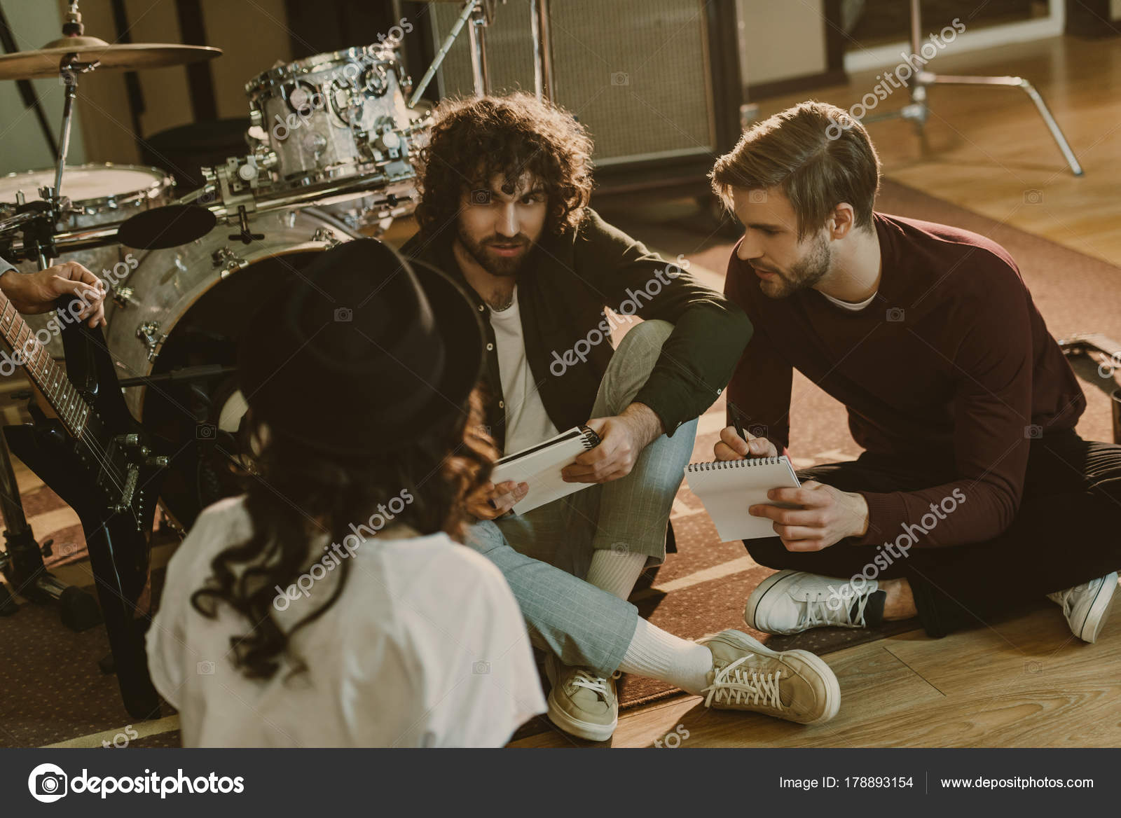 Young Band Writing Music Together While Sitting Floor — Stock Photo ...