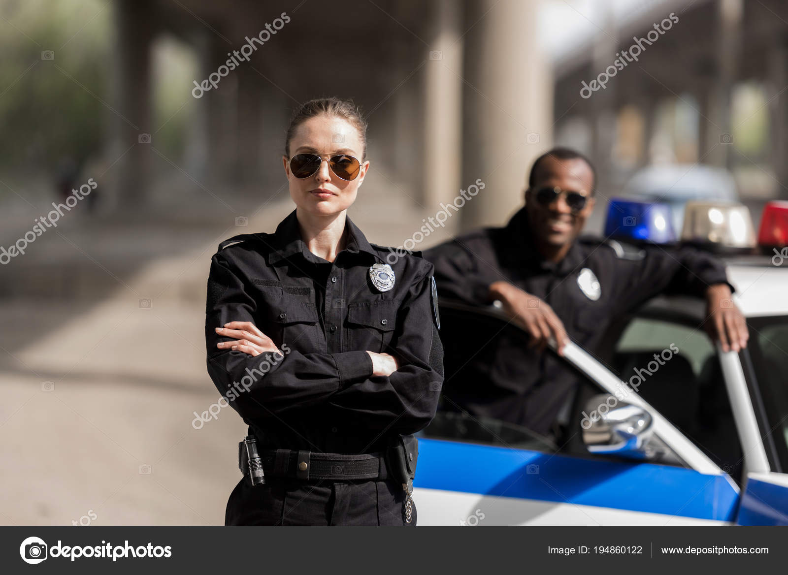 Young Serious Policewoman Standing Crossed Arms While Her Partner ...