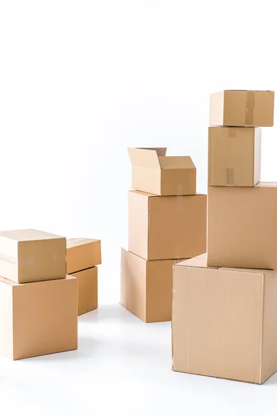 Stacked cardboard boxes — delivery, relocating - Stock Photo | #138794536 Stacked cardboard boxes — delivery, relocating - Stock Photo | #138794536