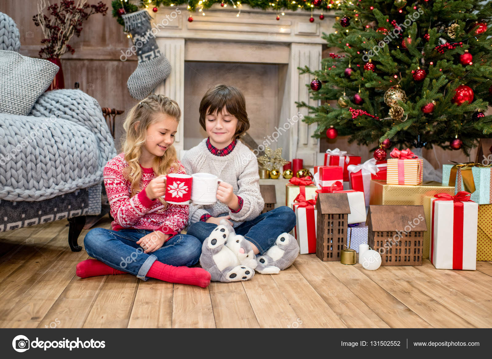 Children sitting near gift boxes — Stock Photo © SergKovbasyuk #131502552