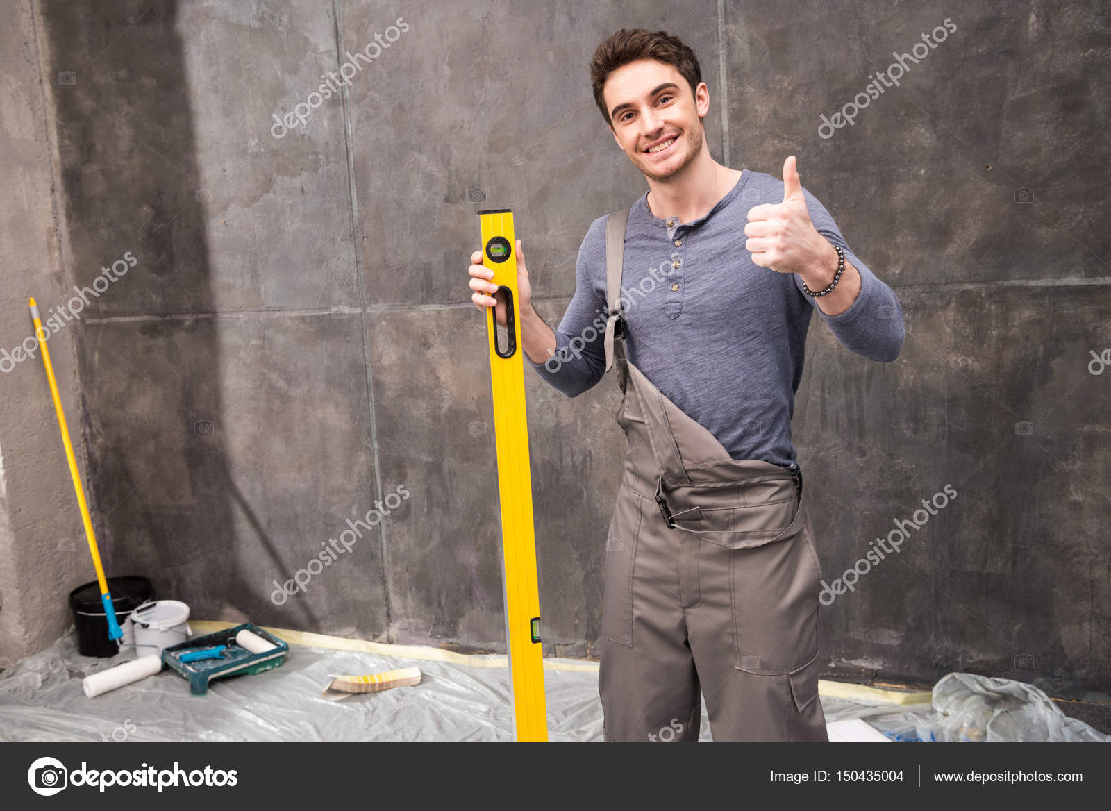 Young laborer with level tool — Stock Photo © DmitryPoch #150435004