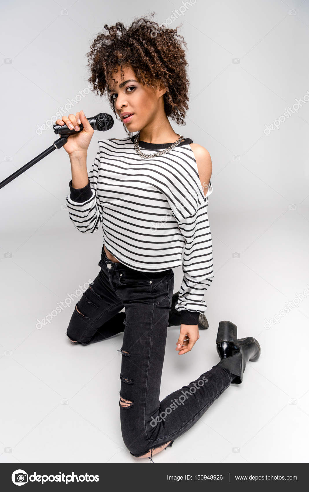 Young singer with microphone — Stock Photo © DmitryPoch #150948926