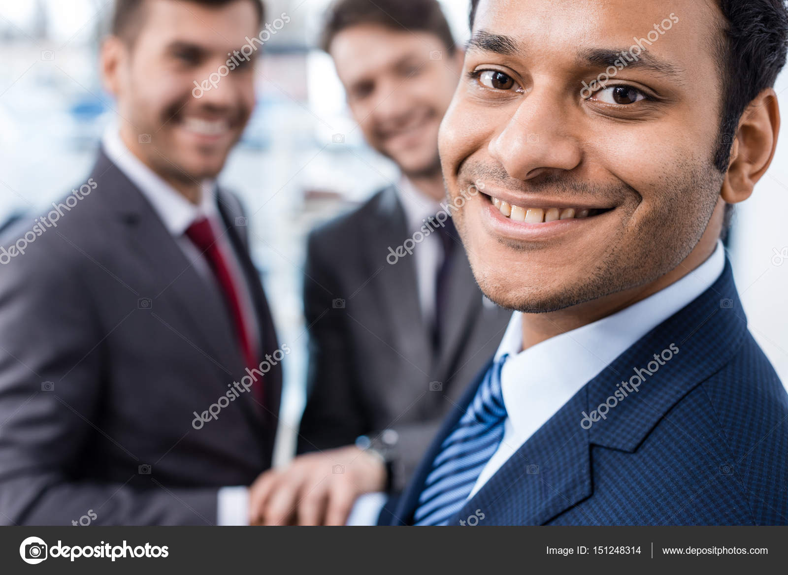 Smiling businessman with colleagues — Stock Photo © DmitryPoch #151248314 Smiling businessman with colleagues — Stock Photo © DmitryPoch #151248314