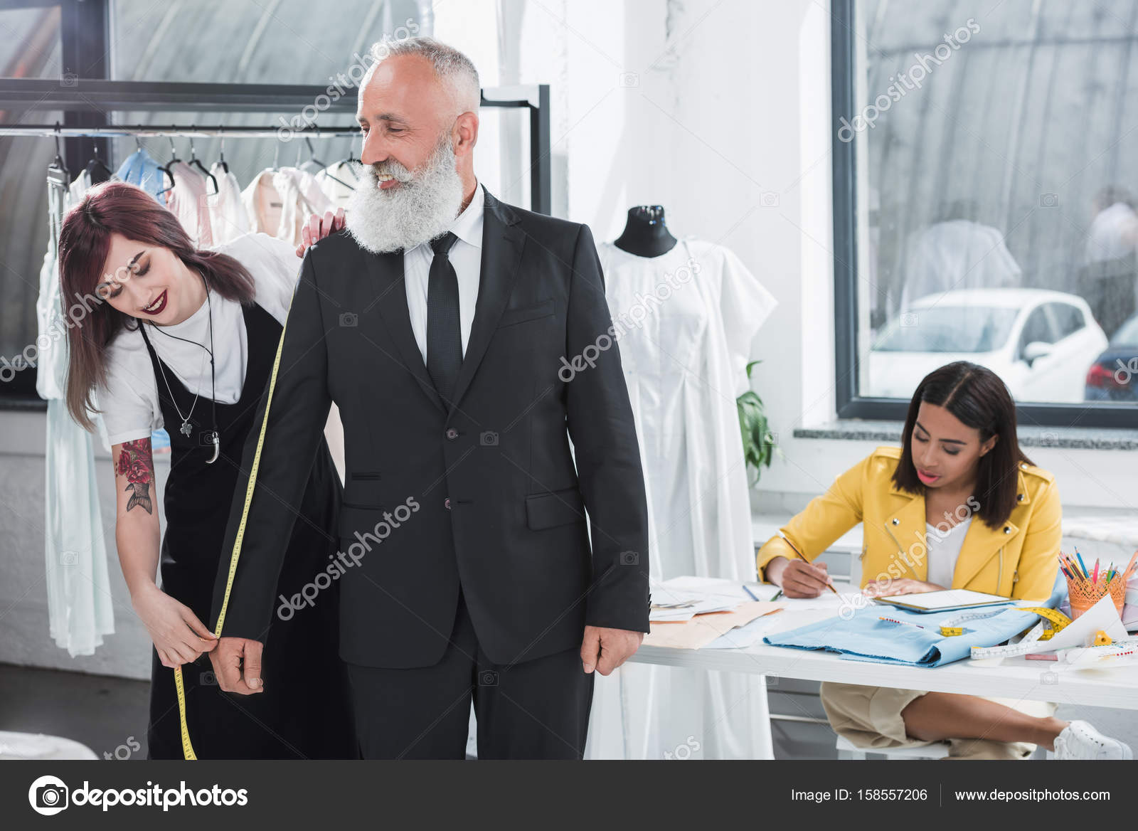 Tailor fitting grey haired man — Stock Photo © DmitryPoch #158557206