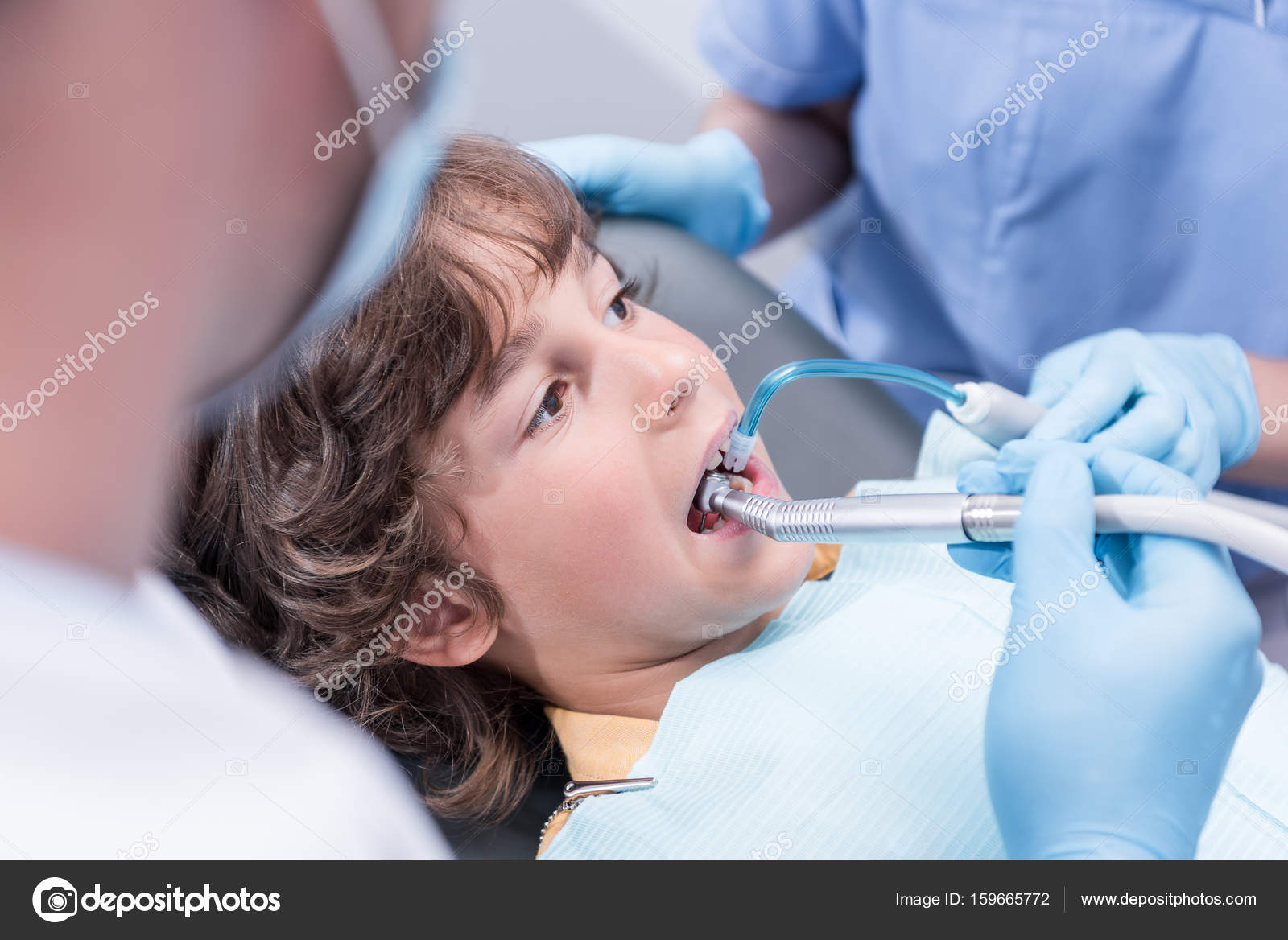 Dentists treating patients teeth — Stock Photo © DmitryPoch #159665772 Dentists treating patients teeth — Stock Photo © DmitryPoch #159665772