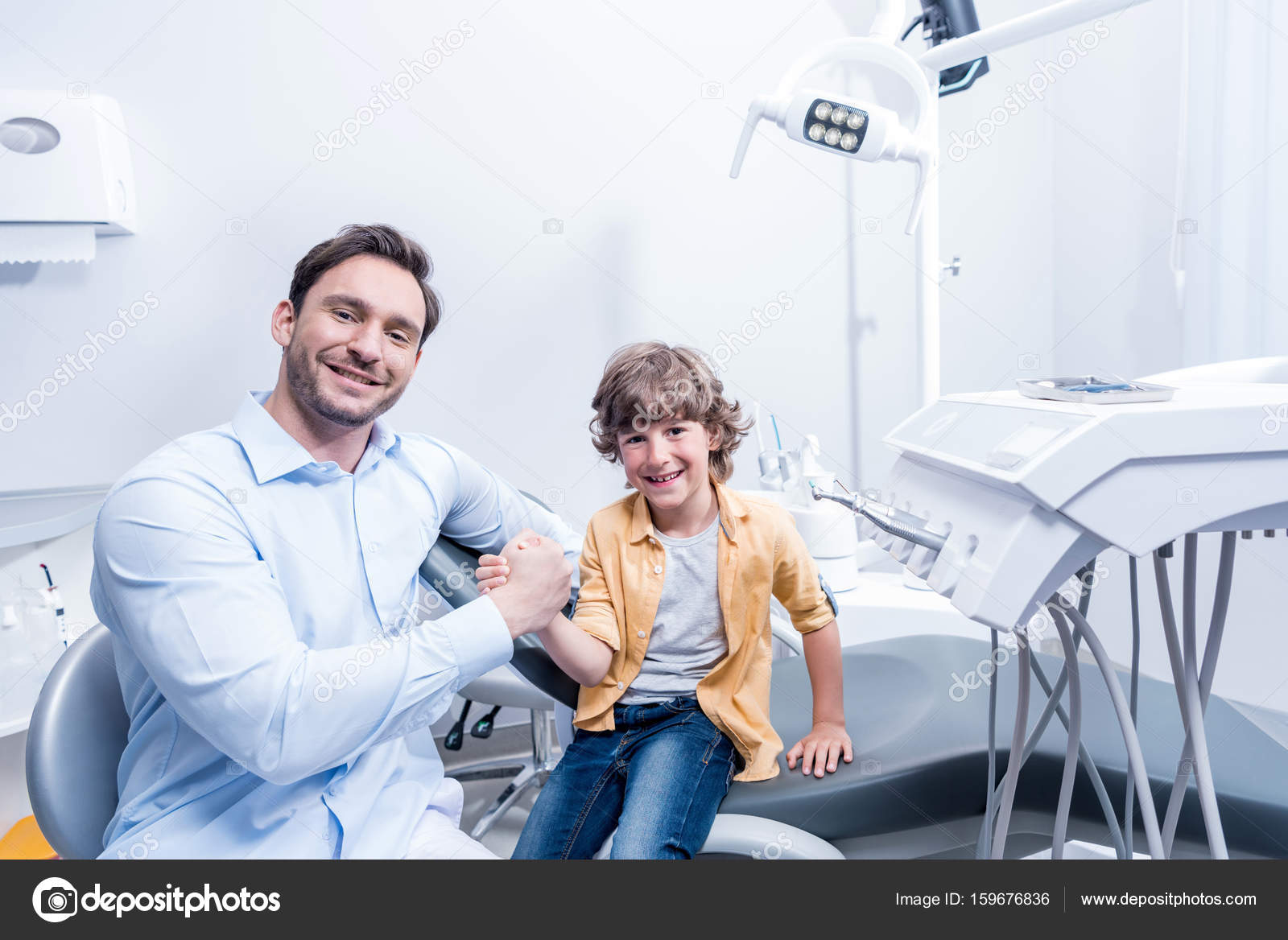 Dentist and boy in dental clinic — Stock Photo © DmitryPoch #159676836