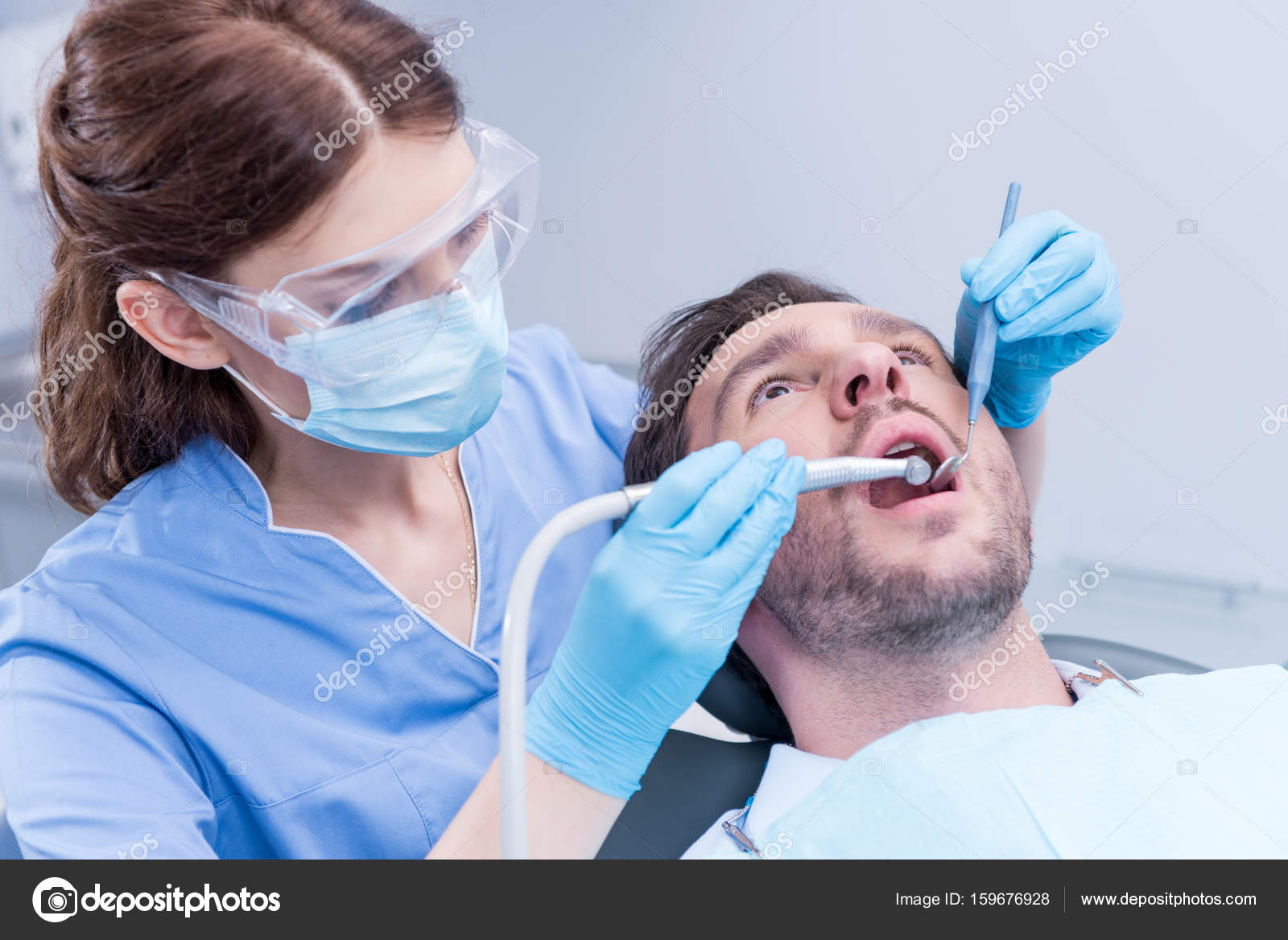 Dentist curing patients teeth Stock Photo by ©DmitryPoch 159676928