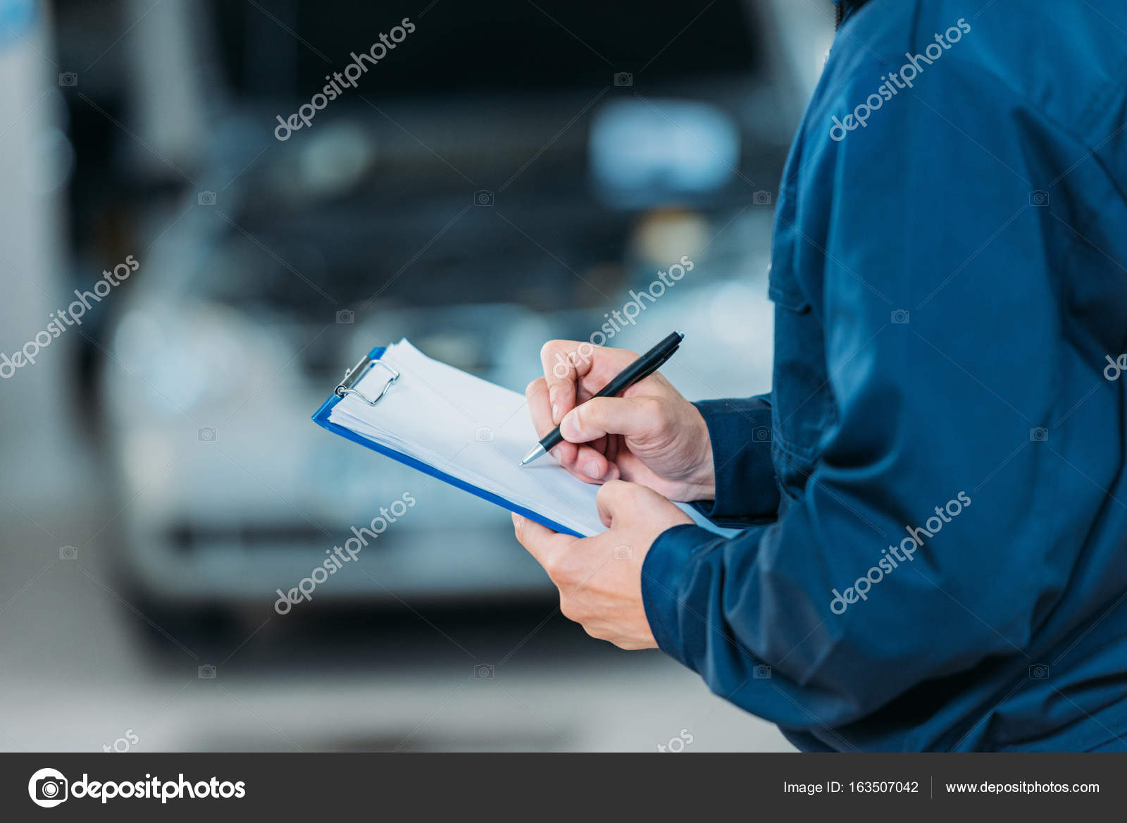 Automechanic writing on clipboard — Stock Photo © DmitryPoch #163507042