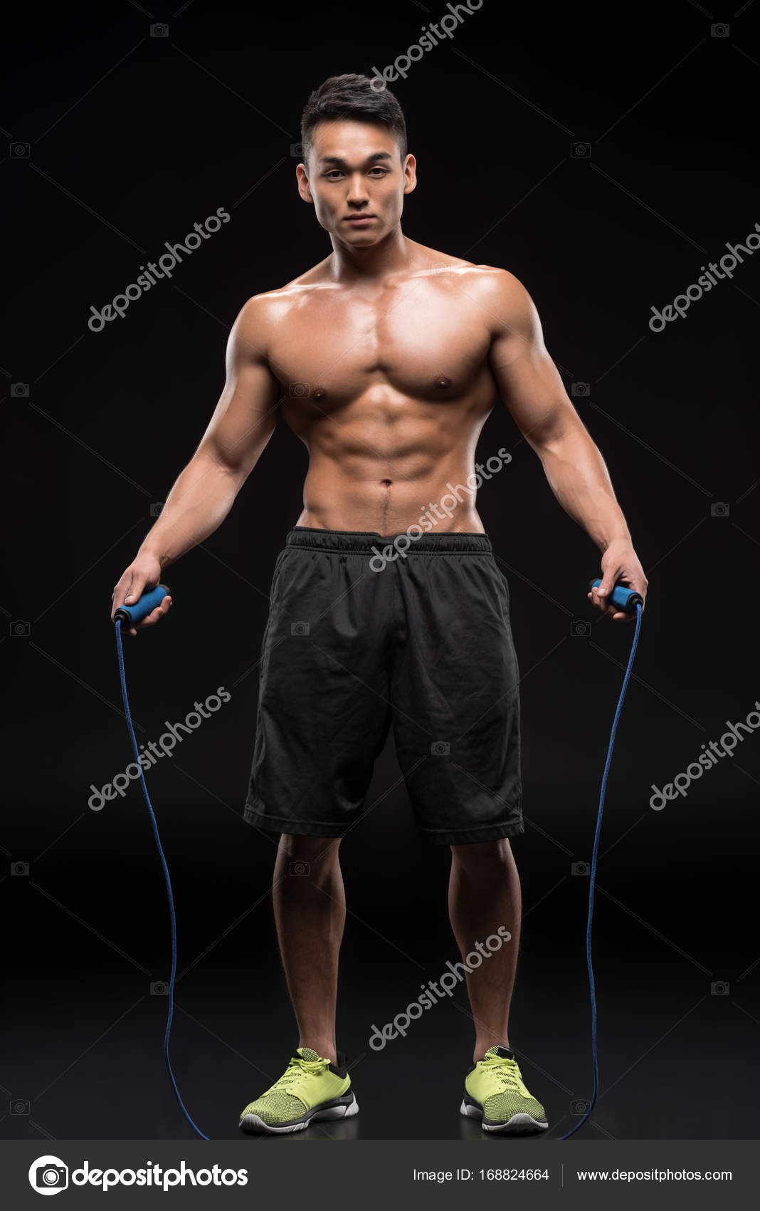 Muscular man with skipping rope — Stock Photo © DmitryPoch #168824664