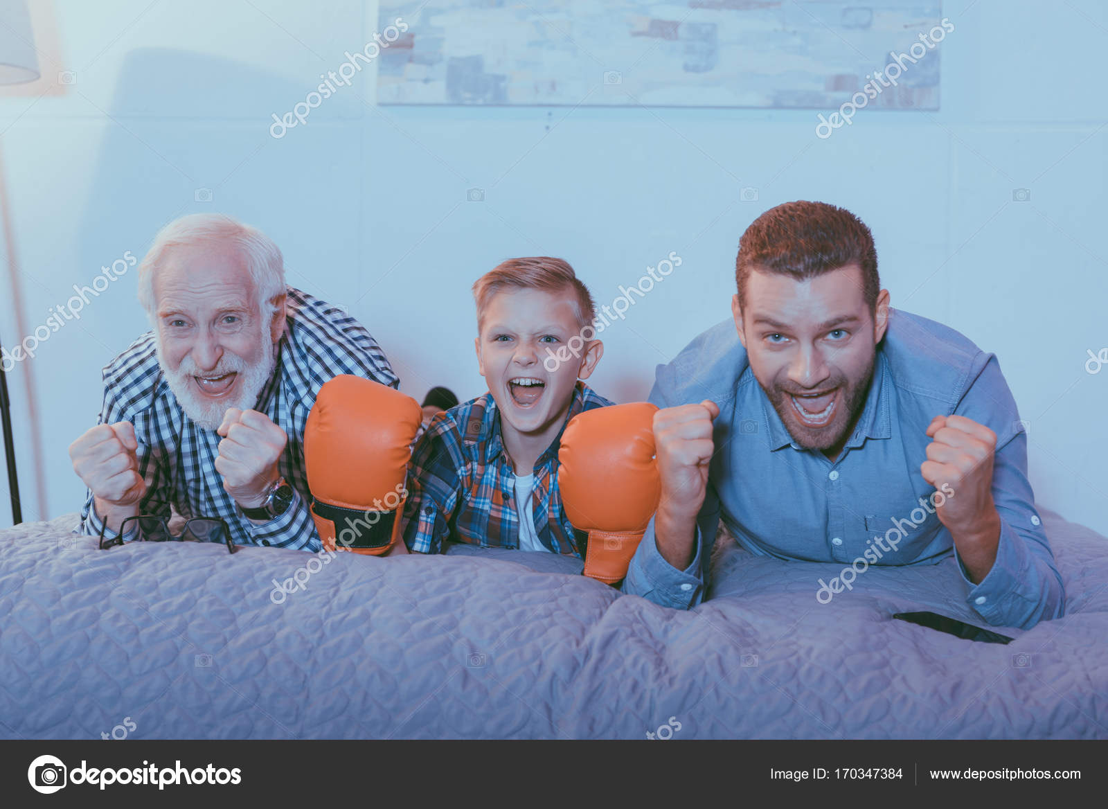 Family watching boxing match on bed — Stock Photo © DmitryPoch #170347384