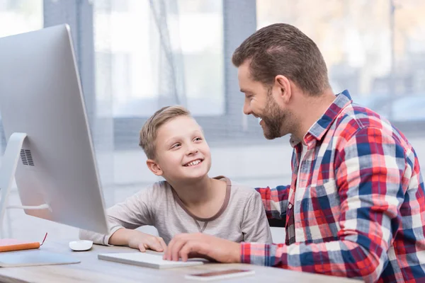 father and son with desktop computer - Stock Image - Everypixel