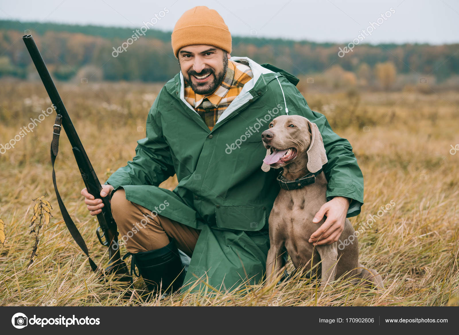 Man squatting with dog and gun Stock Photo by ©DmitryPoch 170902606