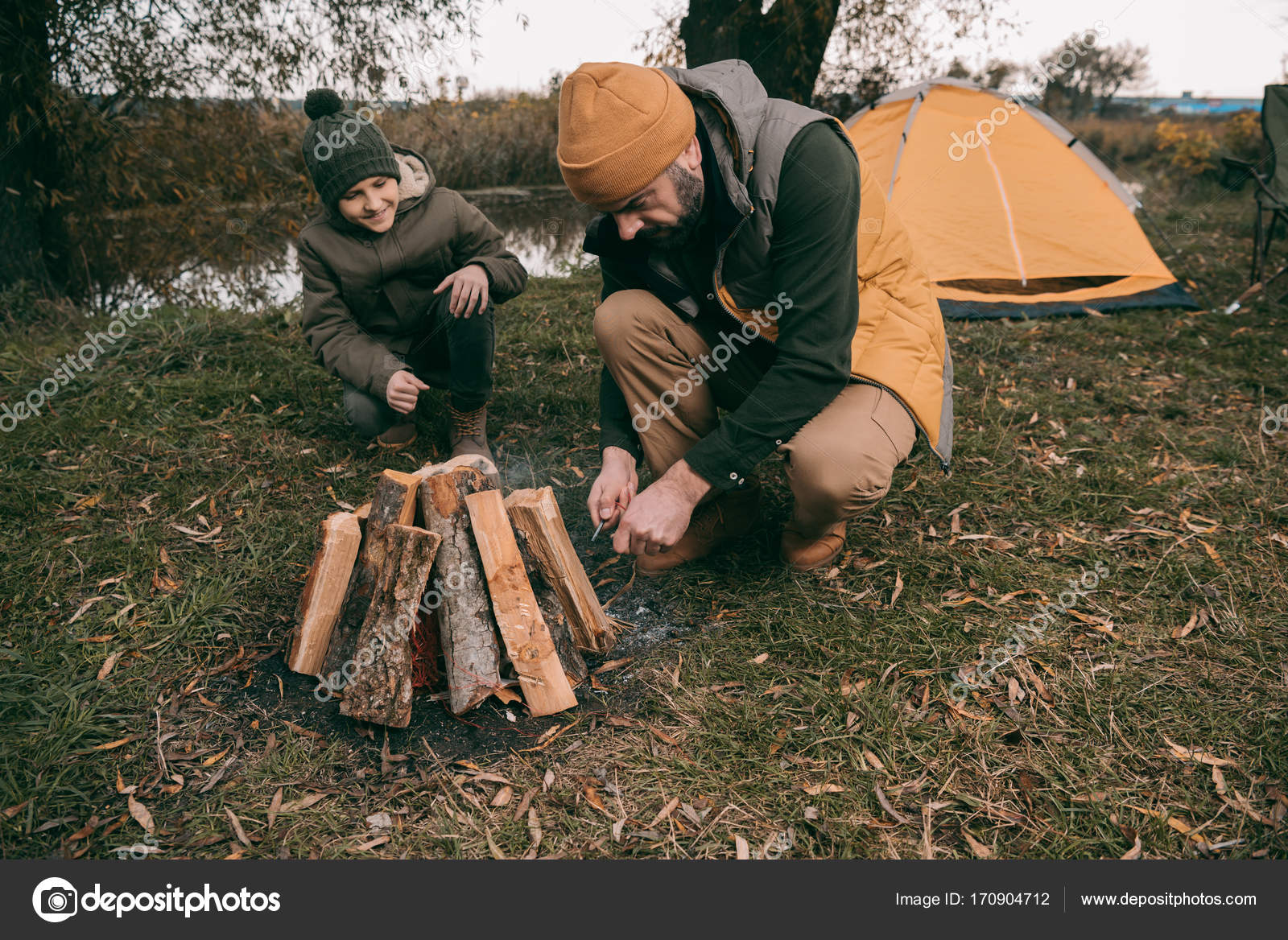Son and father making bonfire Stock Photo by ©DmitryPoch 170904712