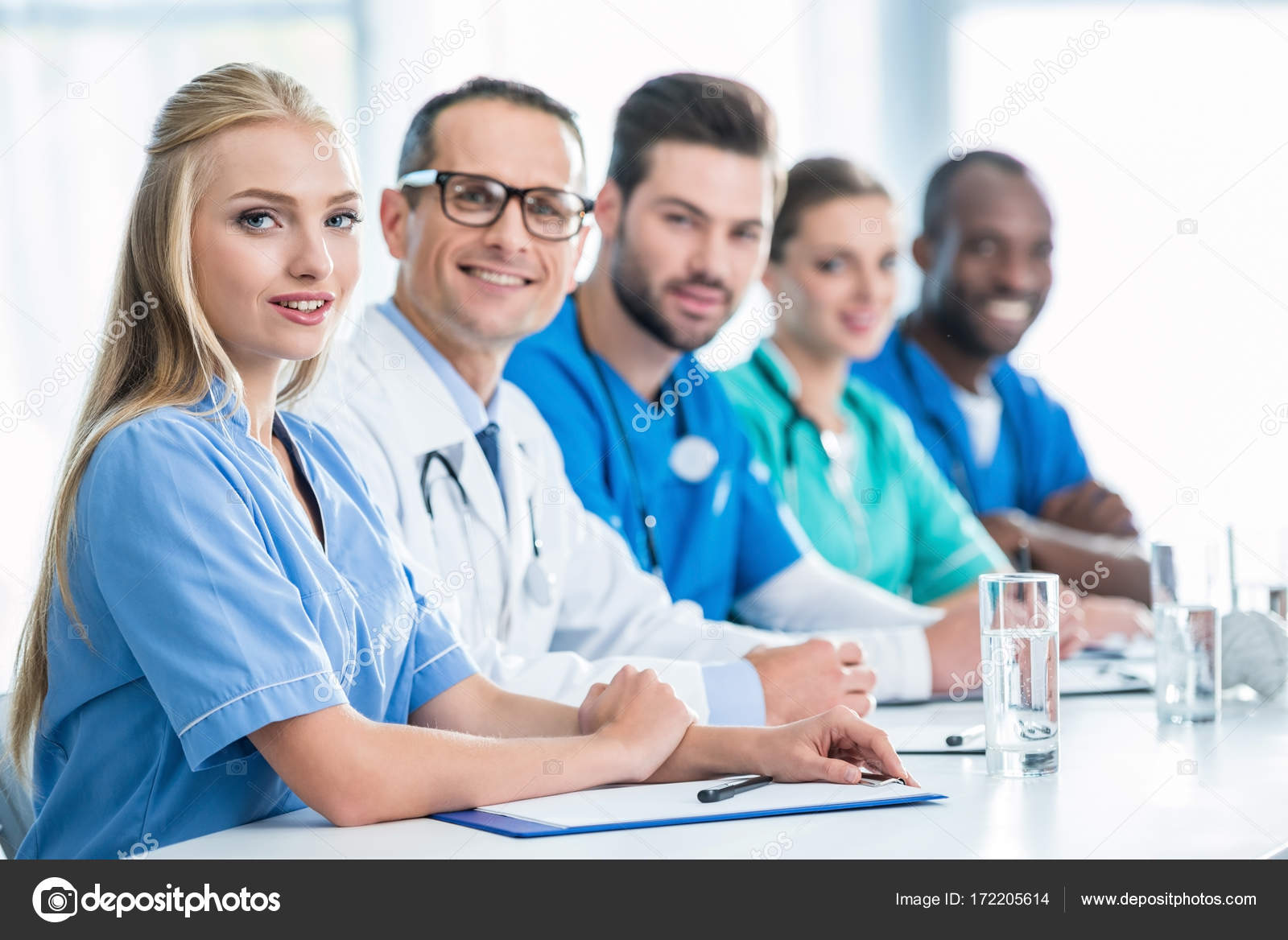 Doctors sitting at table — Stock Photo © DmitryPoch #172205614
