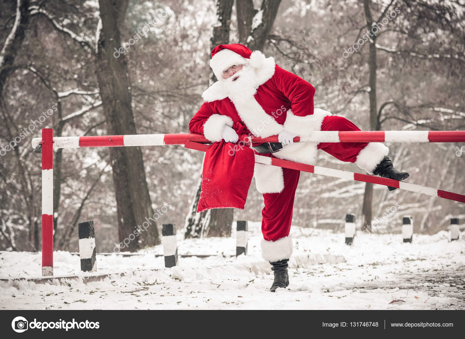 Santa Claus climbing over barrier Stock Photo by ©AndrewLobov 131746748