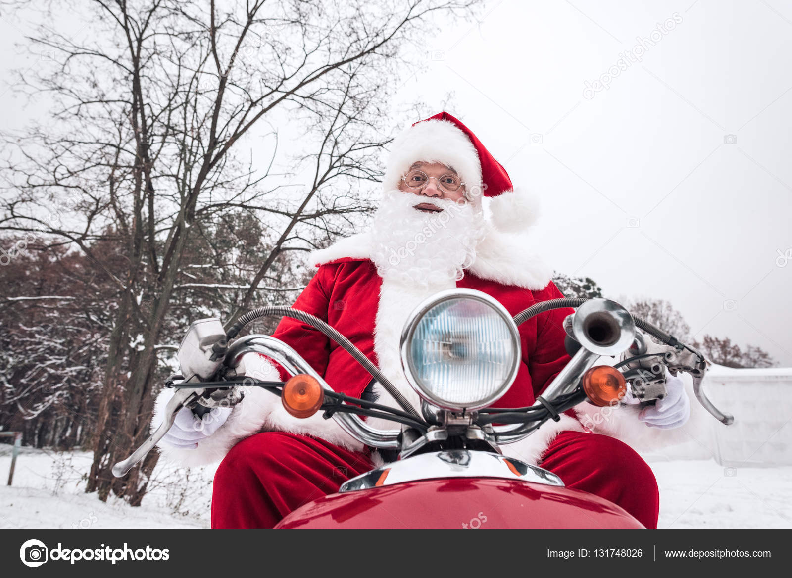 Santa Claus riding red scooter Stock Photo by ©AndrewLobov 131748026