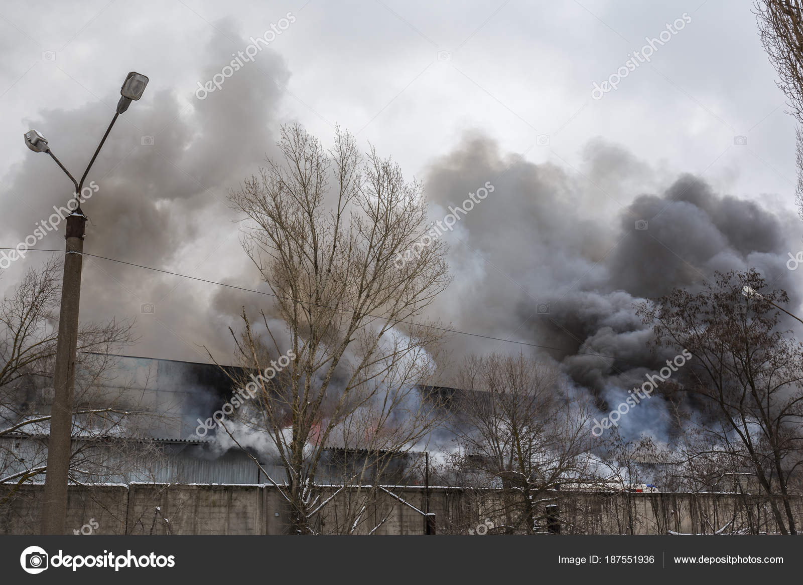 Fire in an industrial warehouse or Factory, lots of smoke and flames ...