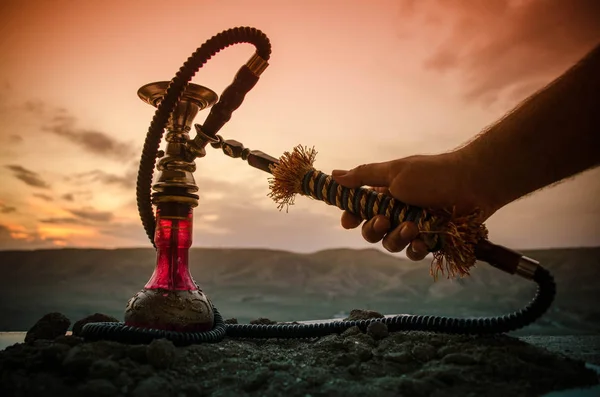 Hookah, traditional arabic waterpipe, direct sunset light, outdoor ...