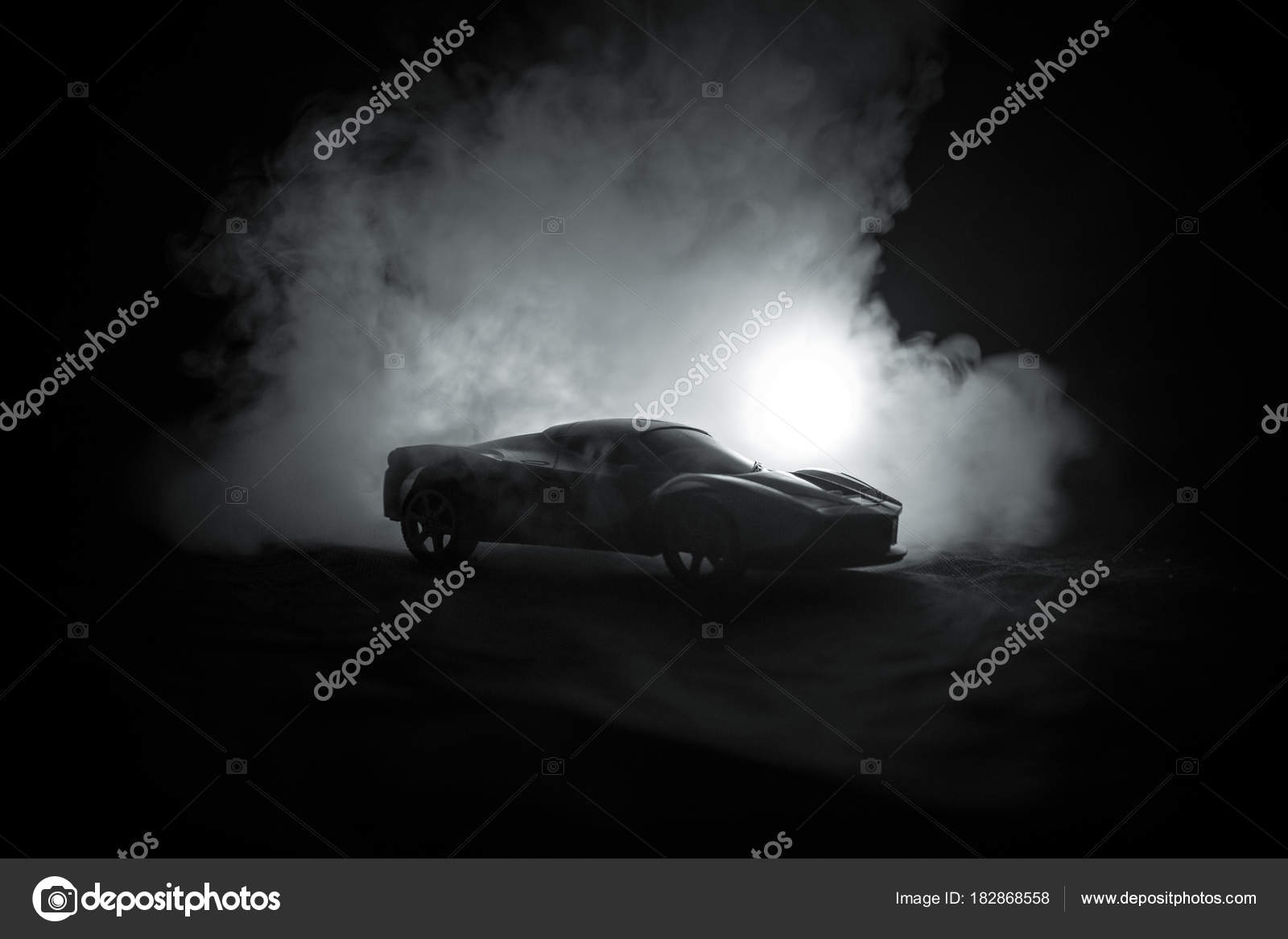 The car in the shadows with glowing lights in low light, or silhouette ...