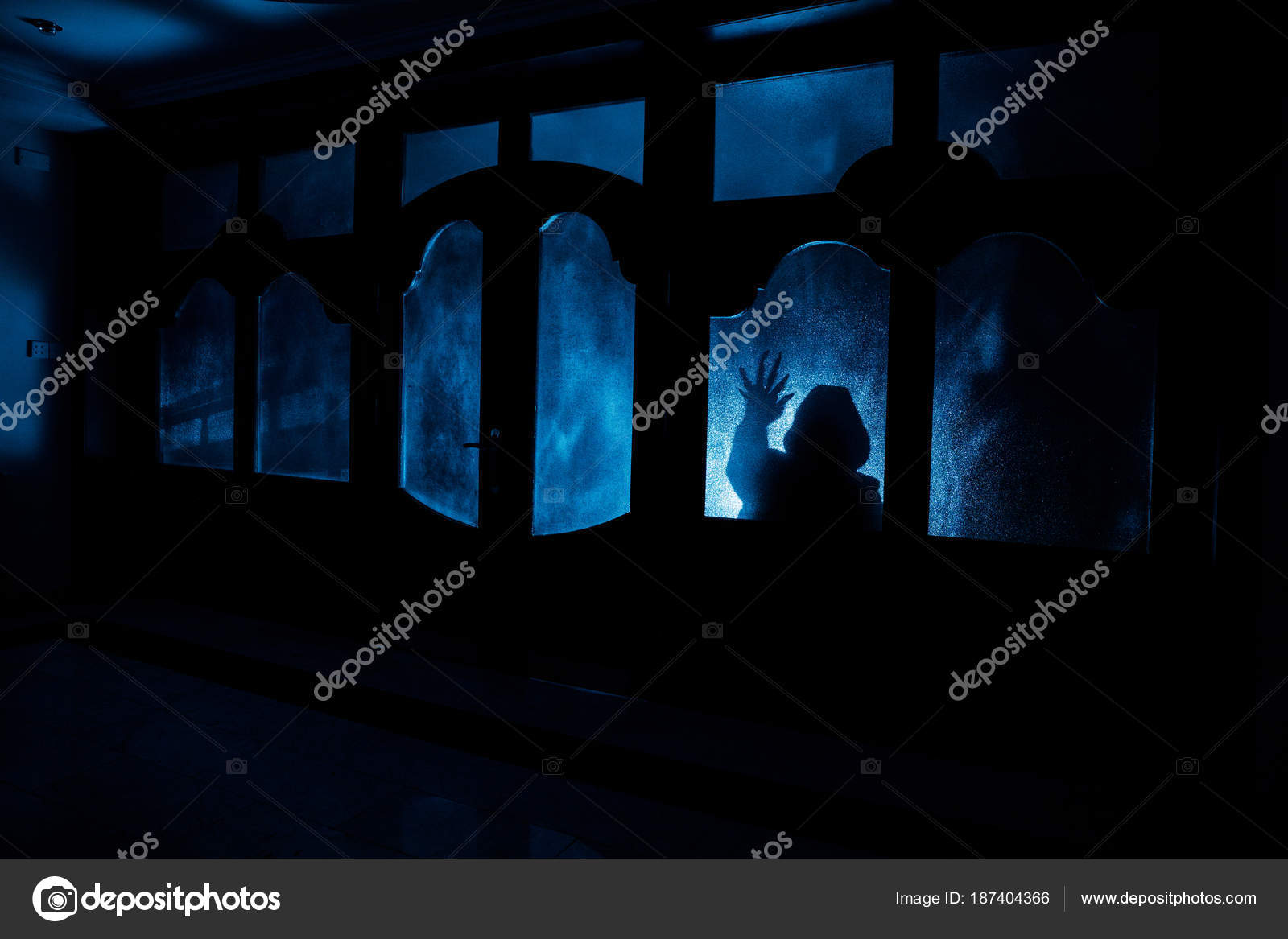 Silhouette of an unknown shadow figure on a door through a close Stock ...