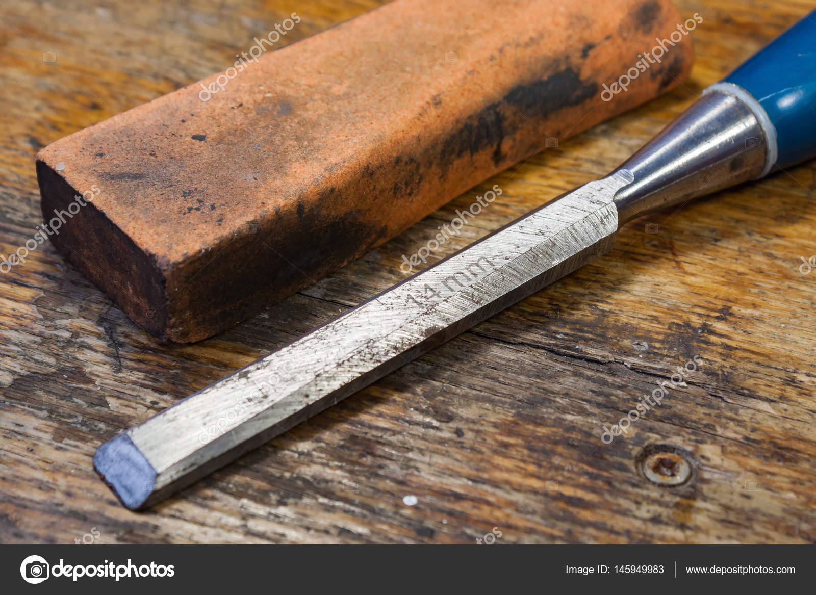 Old chisel and stone for sharpening on a table in a workshop — Stock ...