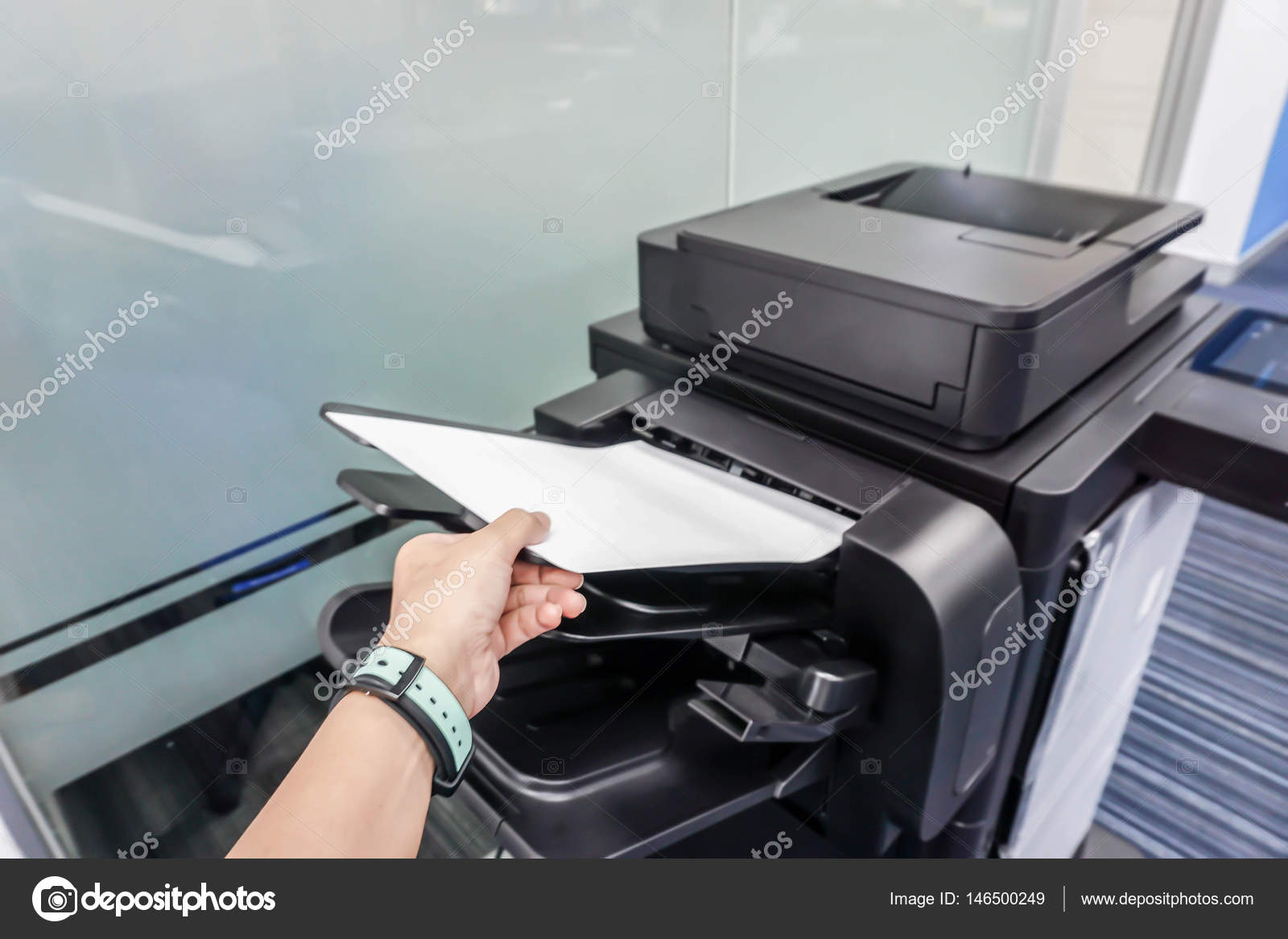 Woman put paper into printer feeder Stock Photo by ©Jummie 146500249