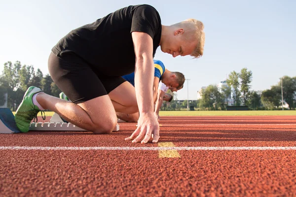 Athletic man starting jogging in sun rays - Stock Image - Everypixel
