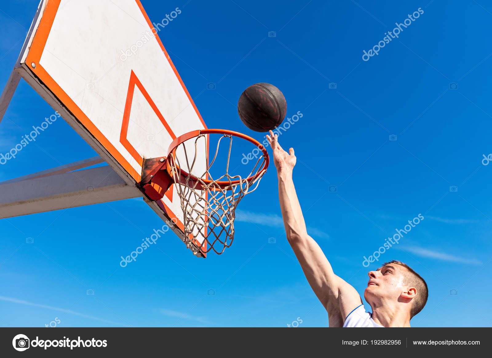 Slam Dunk. Side view of young basketball player making slam dunk Stock ...