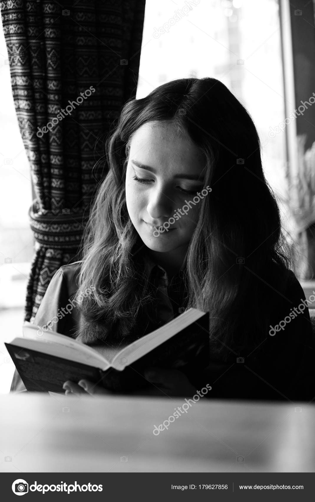 Diligent student female reads a book in a cafe — Free Stock Photo ...