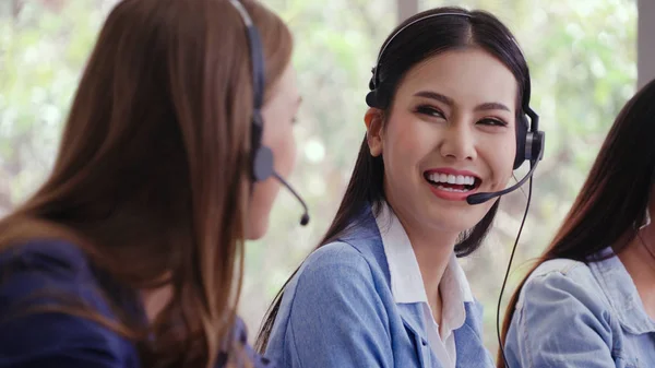 Customer support agent or call center with headset works on desktop ...